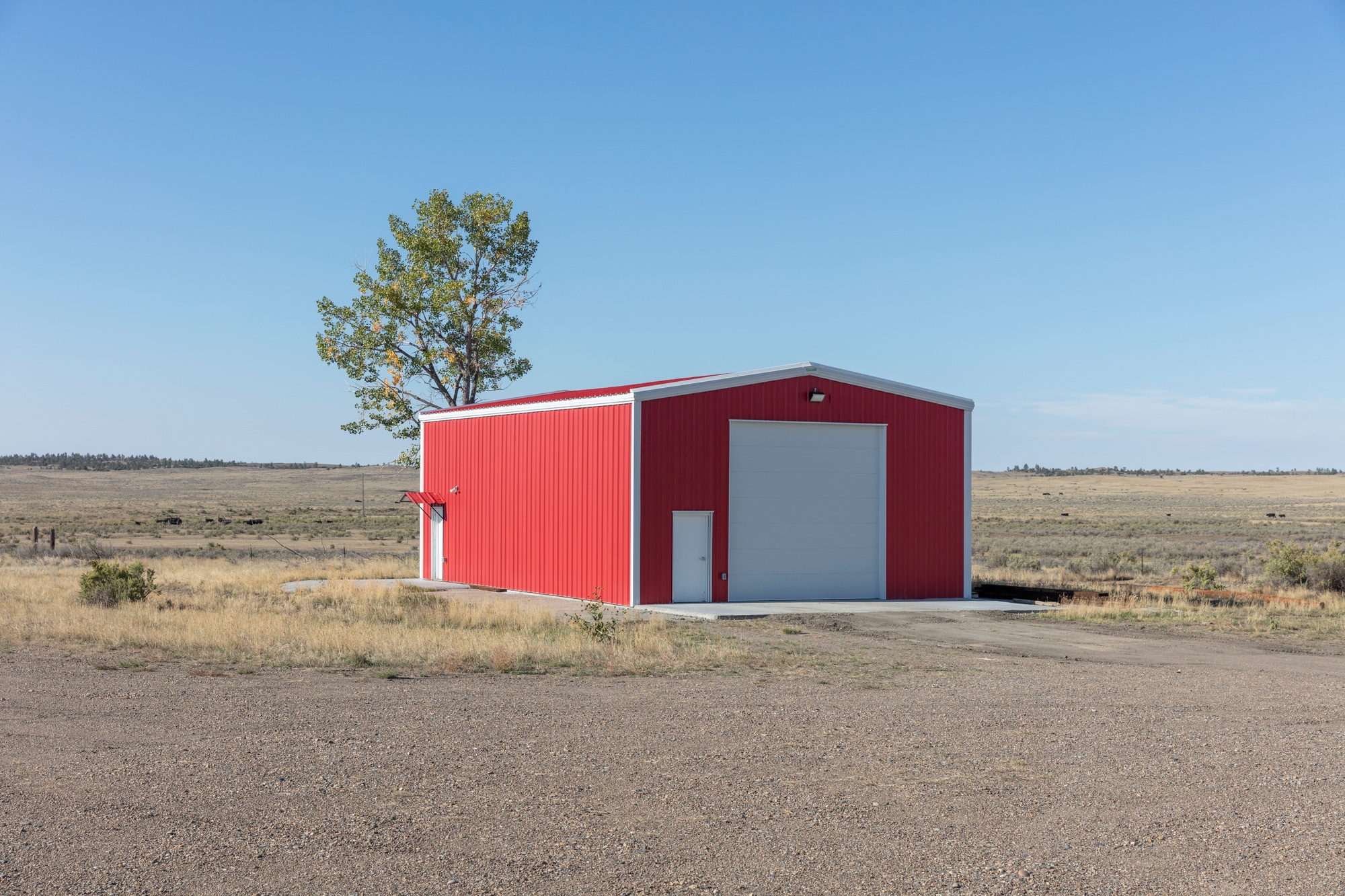 Red Metal Barn in a prairie landscape. | PathwayExteriors